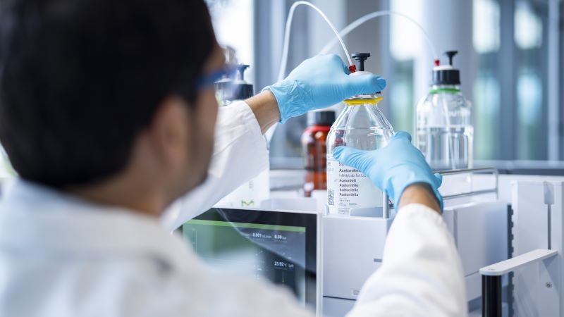 Scientist works with the InfinityLab Level Sensing, which are solvent ...